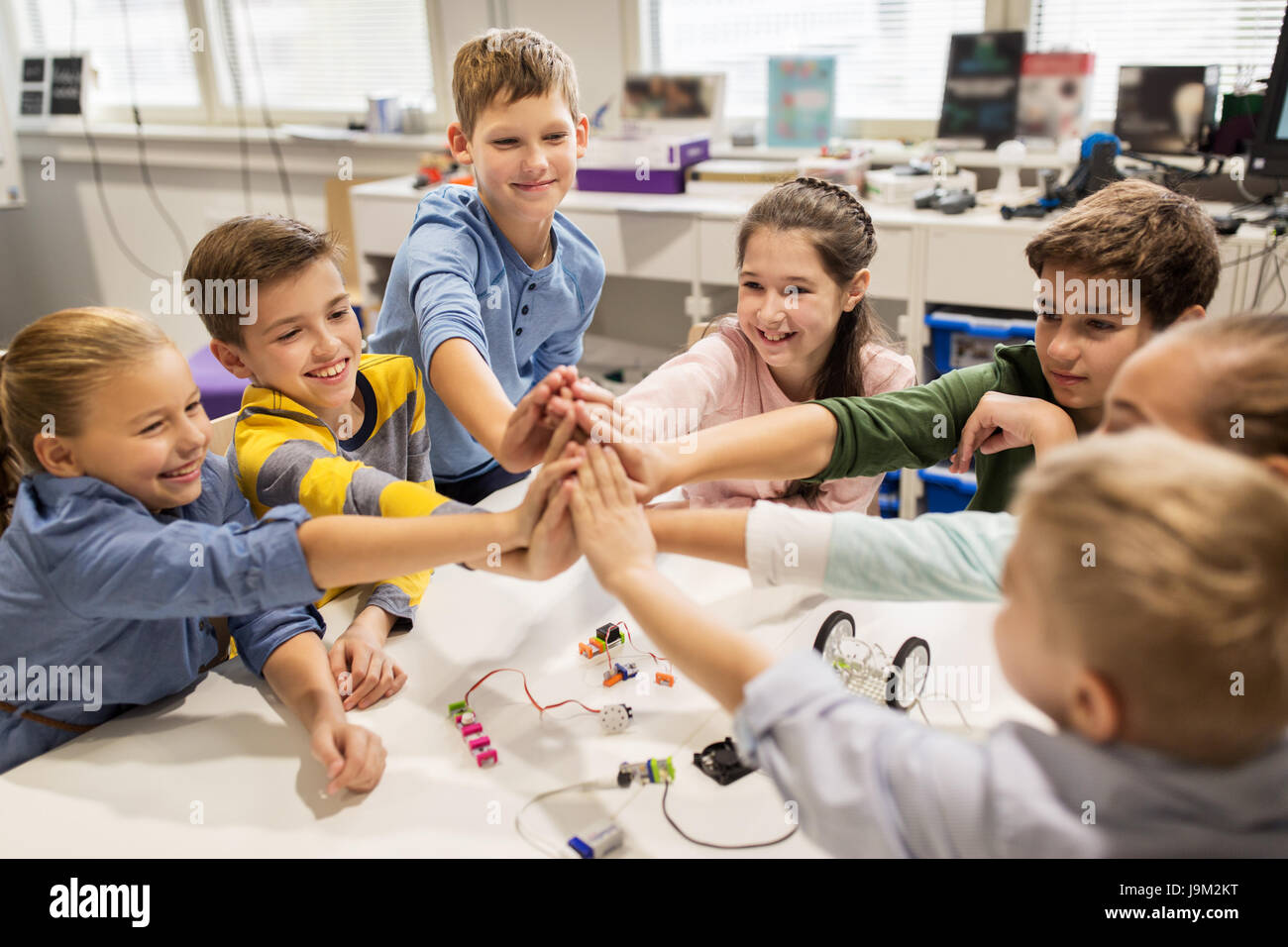 happy children making high five at robotics school Stock Photo - Alamy
