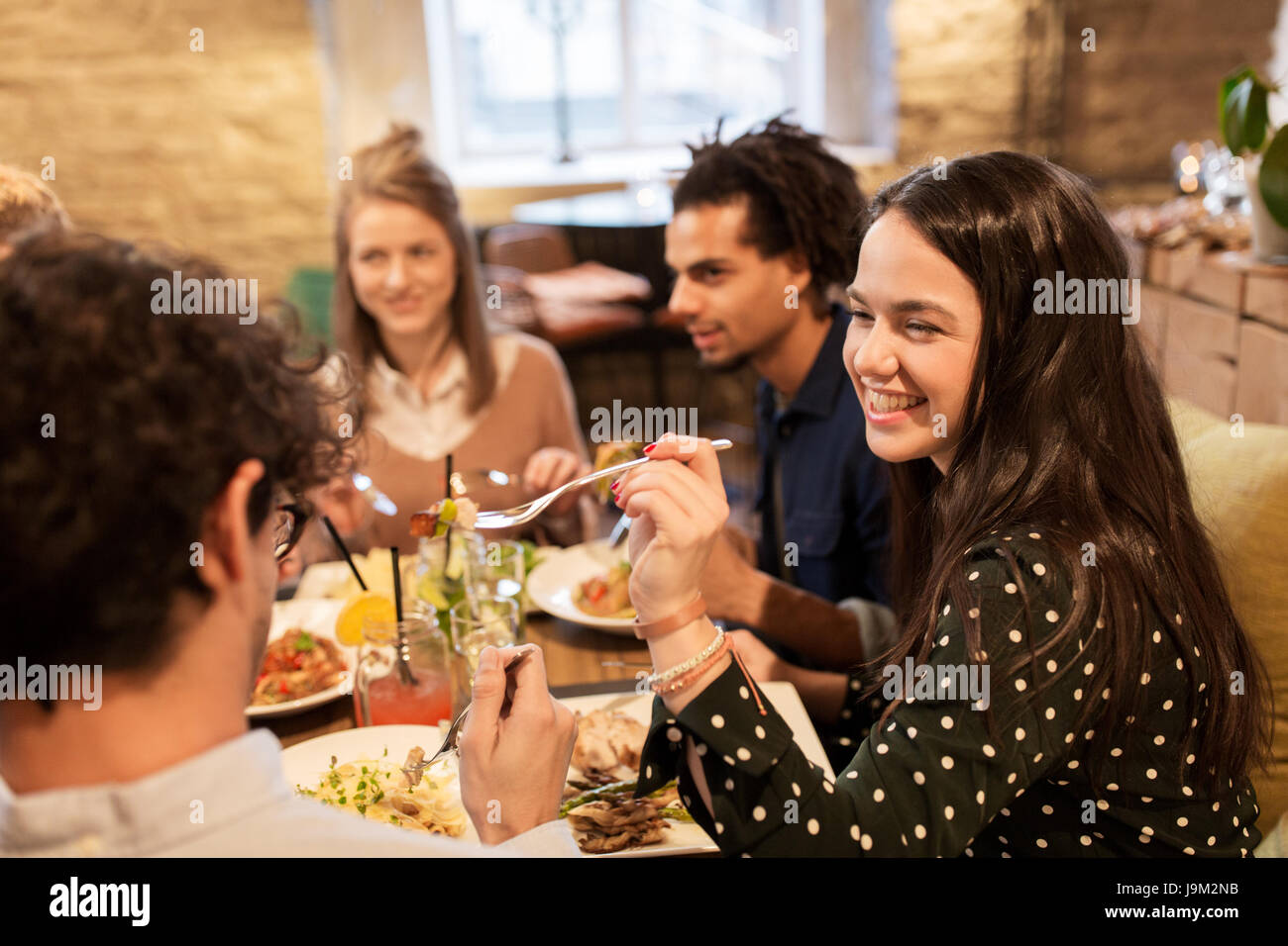 happy friends eating and drinking at restaurant Stock Photo - Alamy