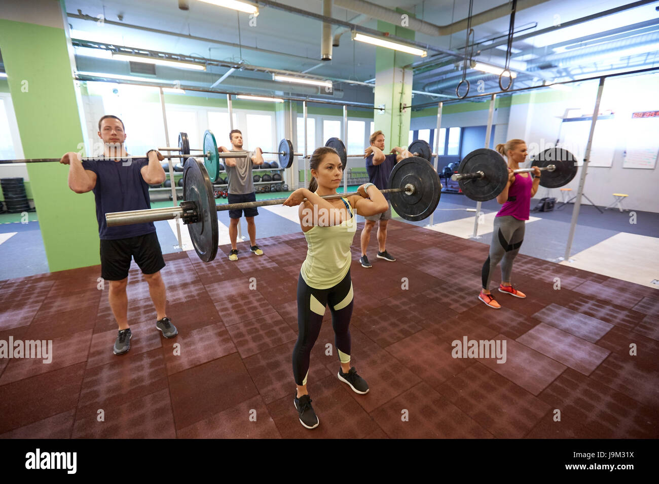 group of people training with barbells in gym Stock Photo - Alamy