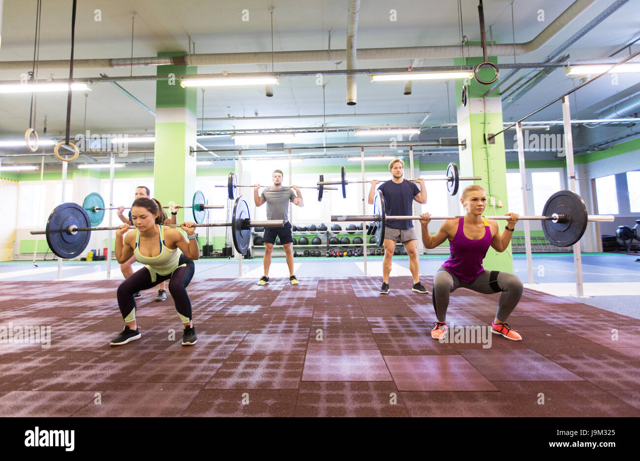 group of people training with barbells in gym Stock Photo - Alamy