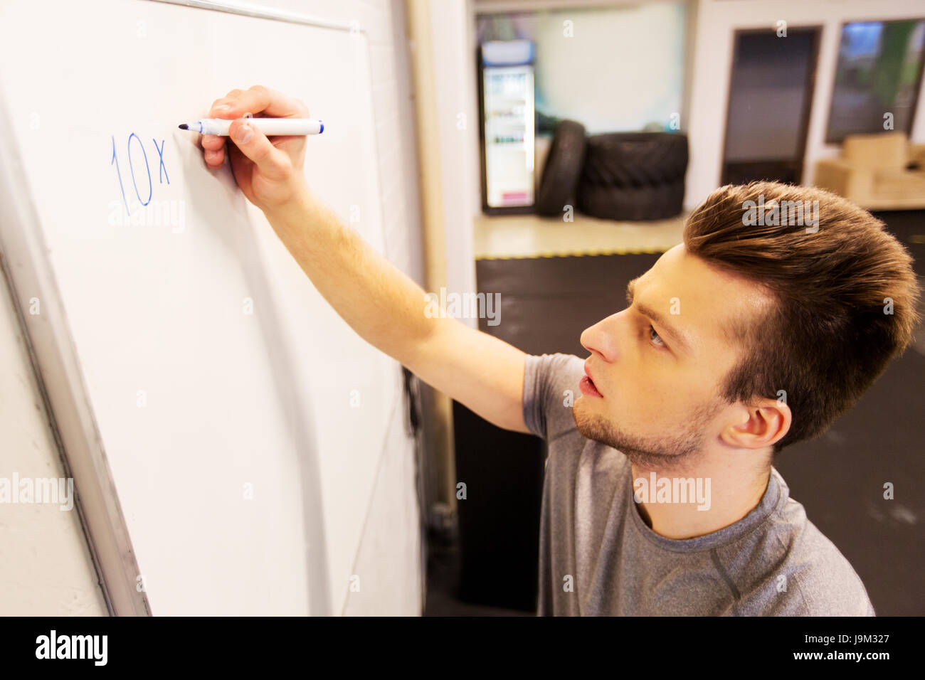 man writing numbers to whiteboard in gym Stock Photo - Alamy
