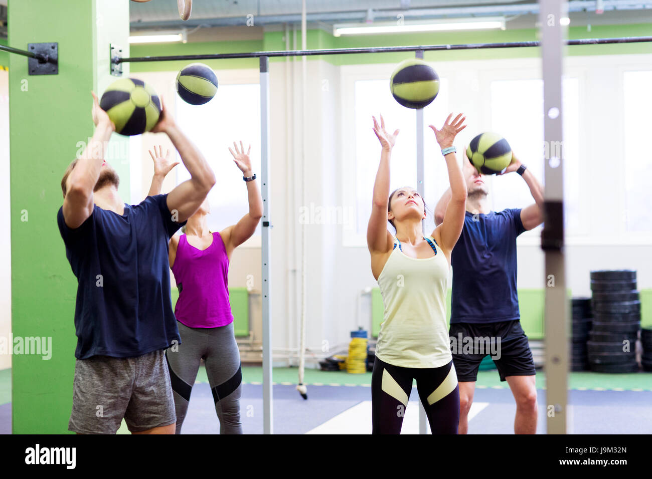 group of people with medicine ball training in gym Stock Photo - Alamy