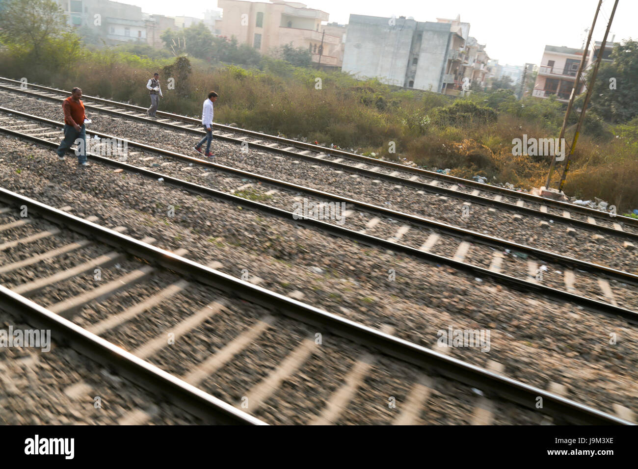 View on railway with people walking on the track from moving train ...