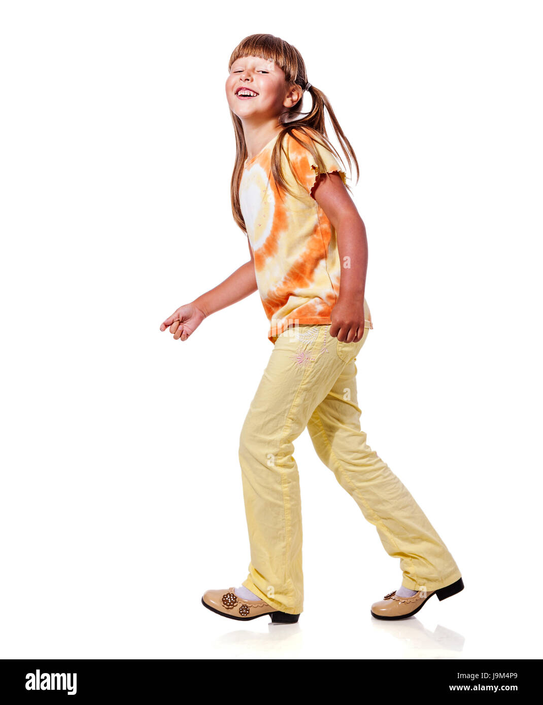 Happy excited walking girl isolated on white Stock Photo - Alamy