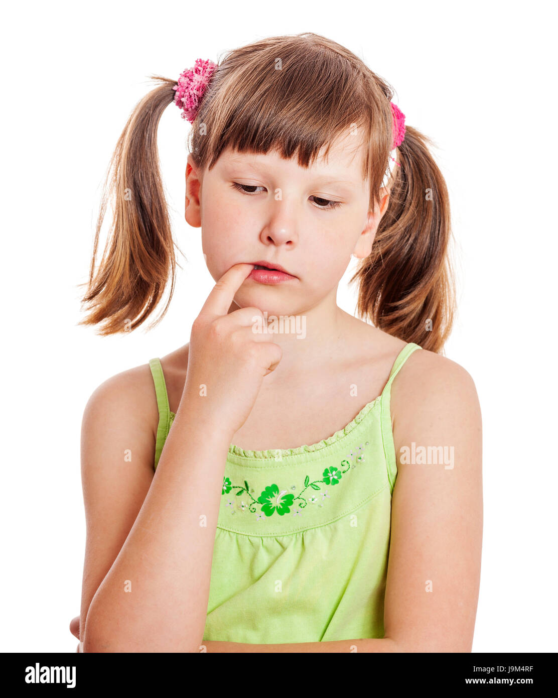 Worried eight years girl biting fingernails isolated Stock Photo - Alamy