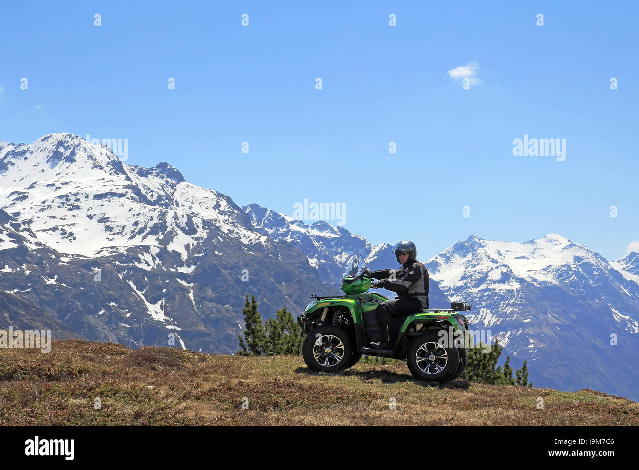 with the atv in the alps Stock Photo - Alamy