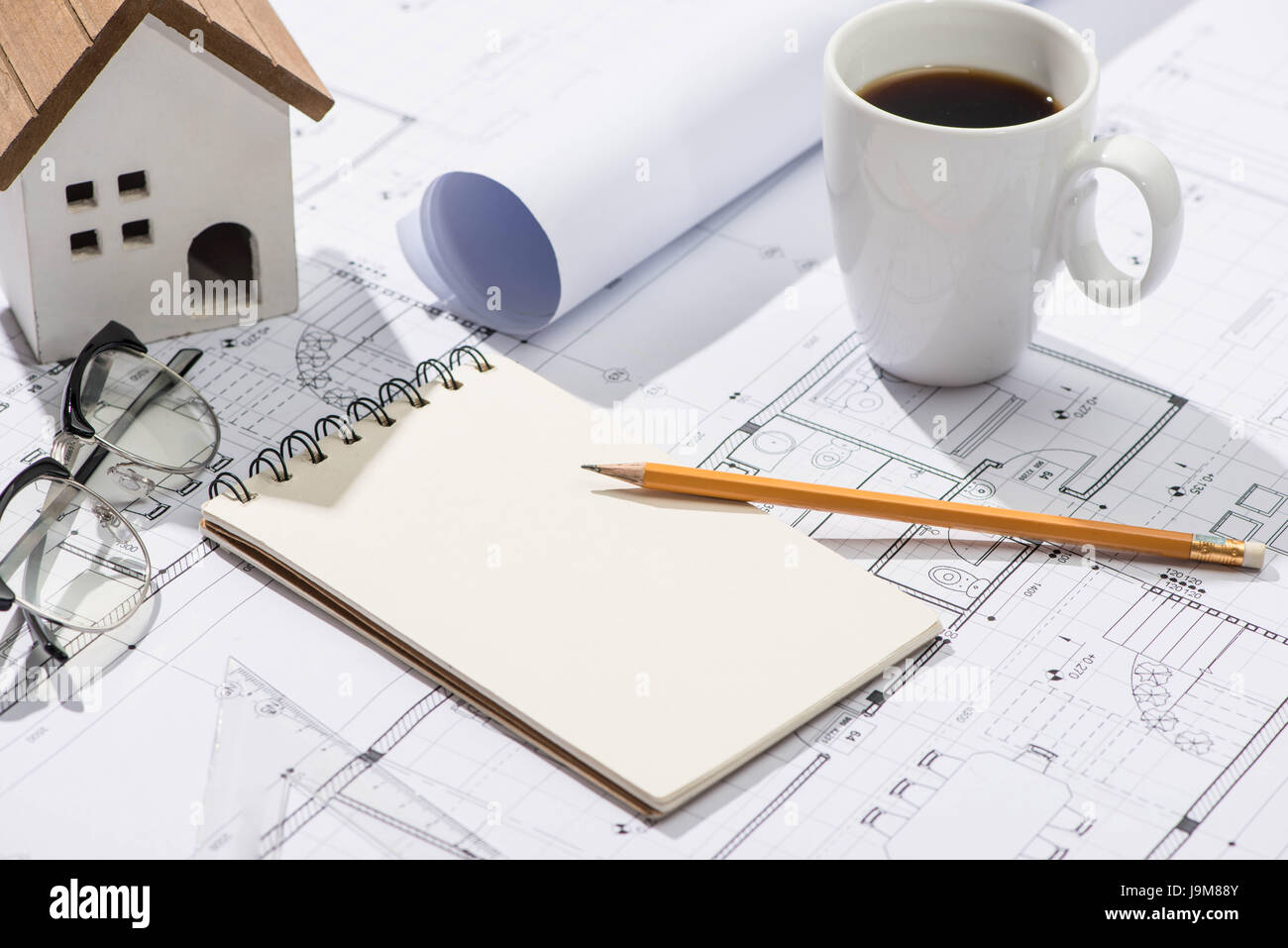 Construction projects. Planning. Open blueprints with a pencil and ...