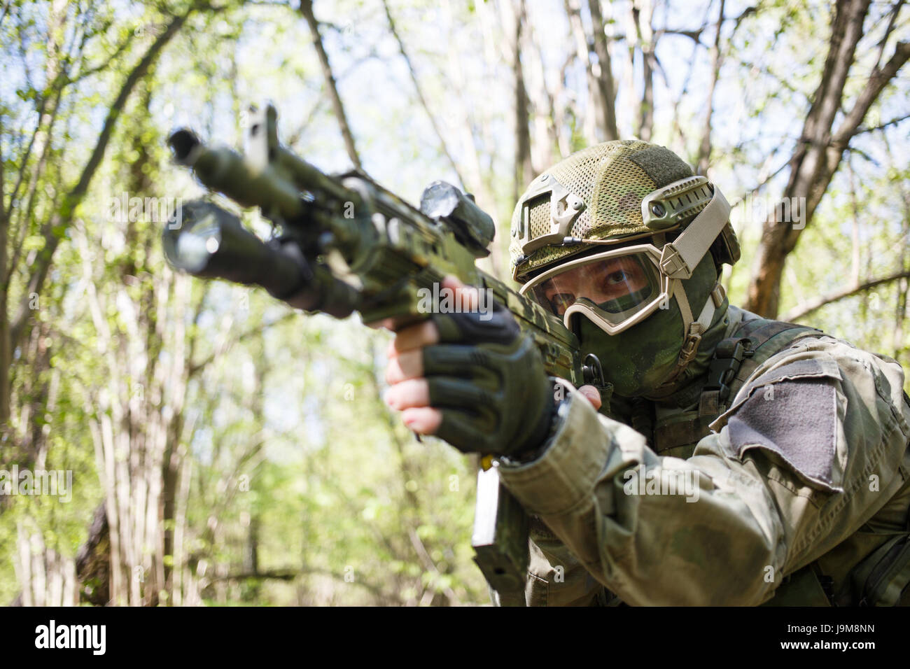 Military man aiming with gun Stock Photo - Alamy
