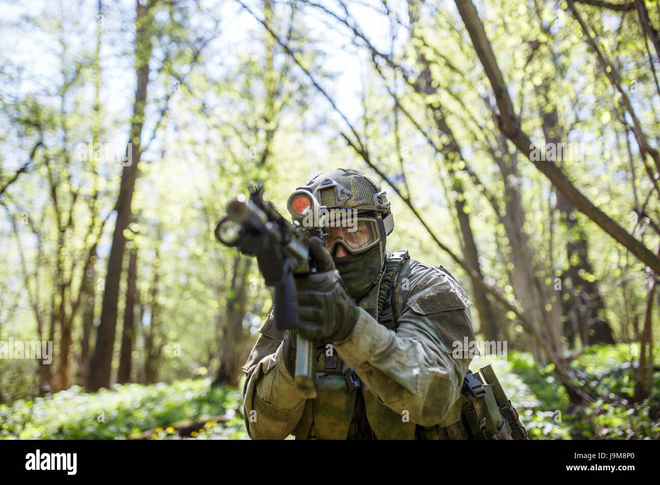 Military man aiming holding gun Stock Photo - Alamy
