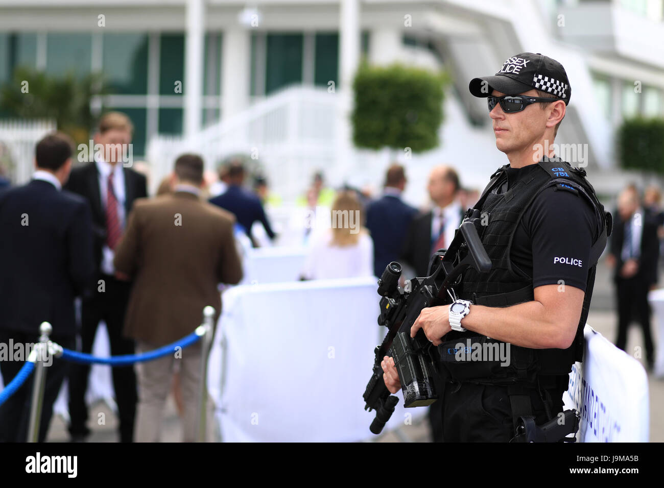 A armed policeman stands on guard on ladies day hi-res stock ...