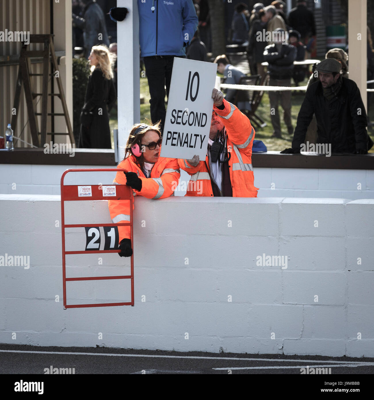 Race officials holding out the 10 Second Penalty board for car number ...