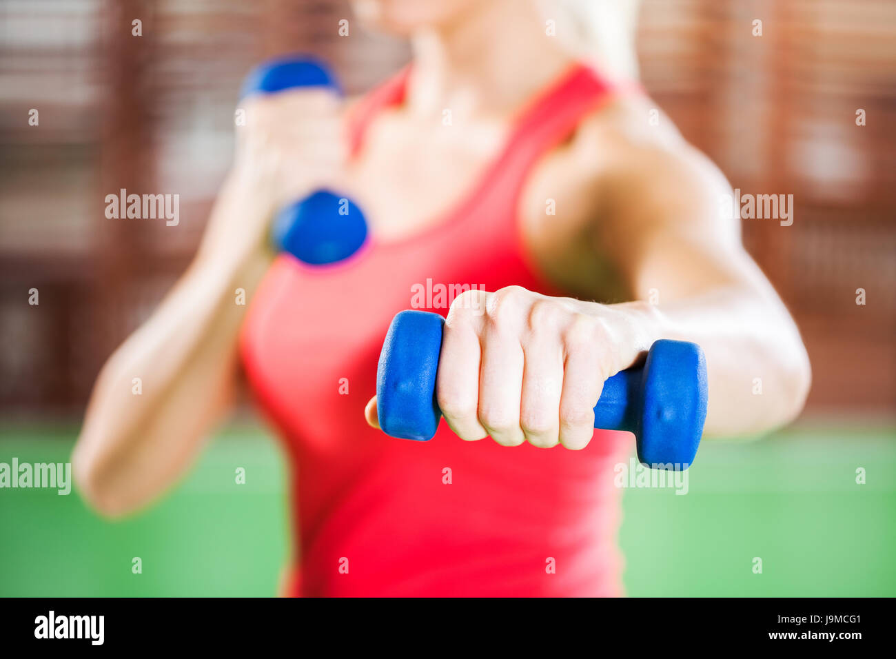 Woman exercising in gym, using weights Stock Photo - Alamy