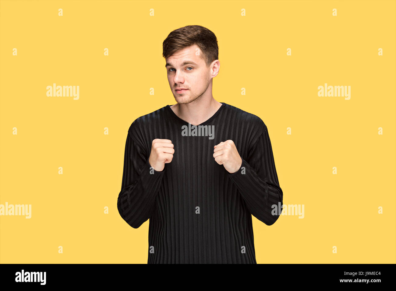 The young man with a raised fist Stock Photo - Alamy
