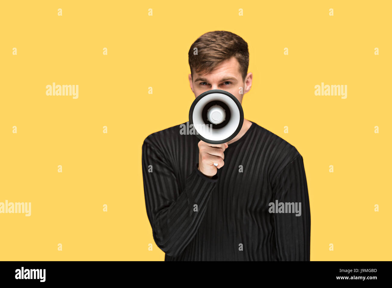 Young businessman loud noise megaphone hi-res stock photography and ...