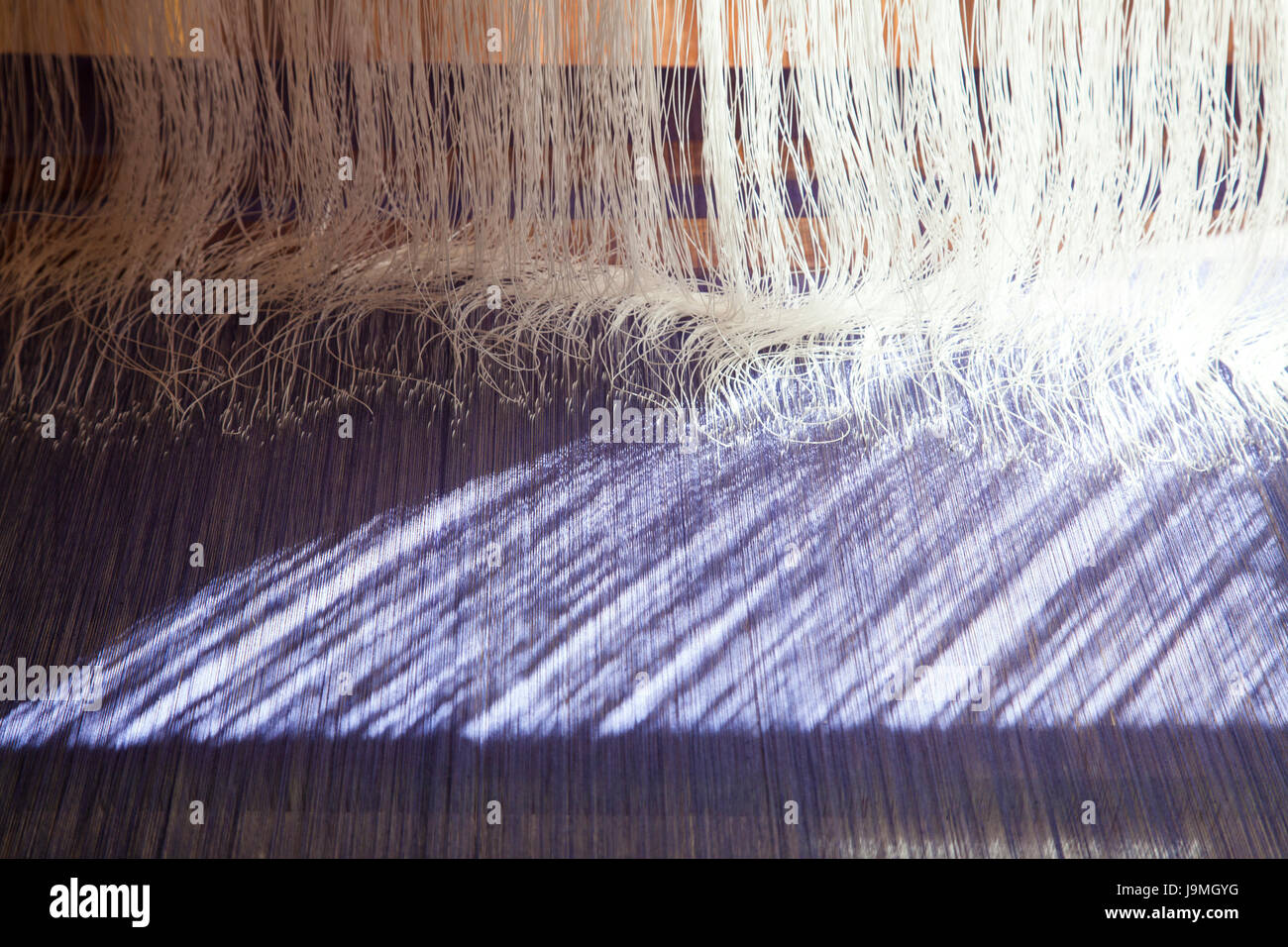 Yarn background, old weaving Loom and thread of yarn. A traditional ...