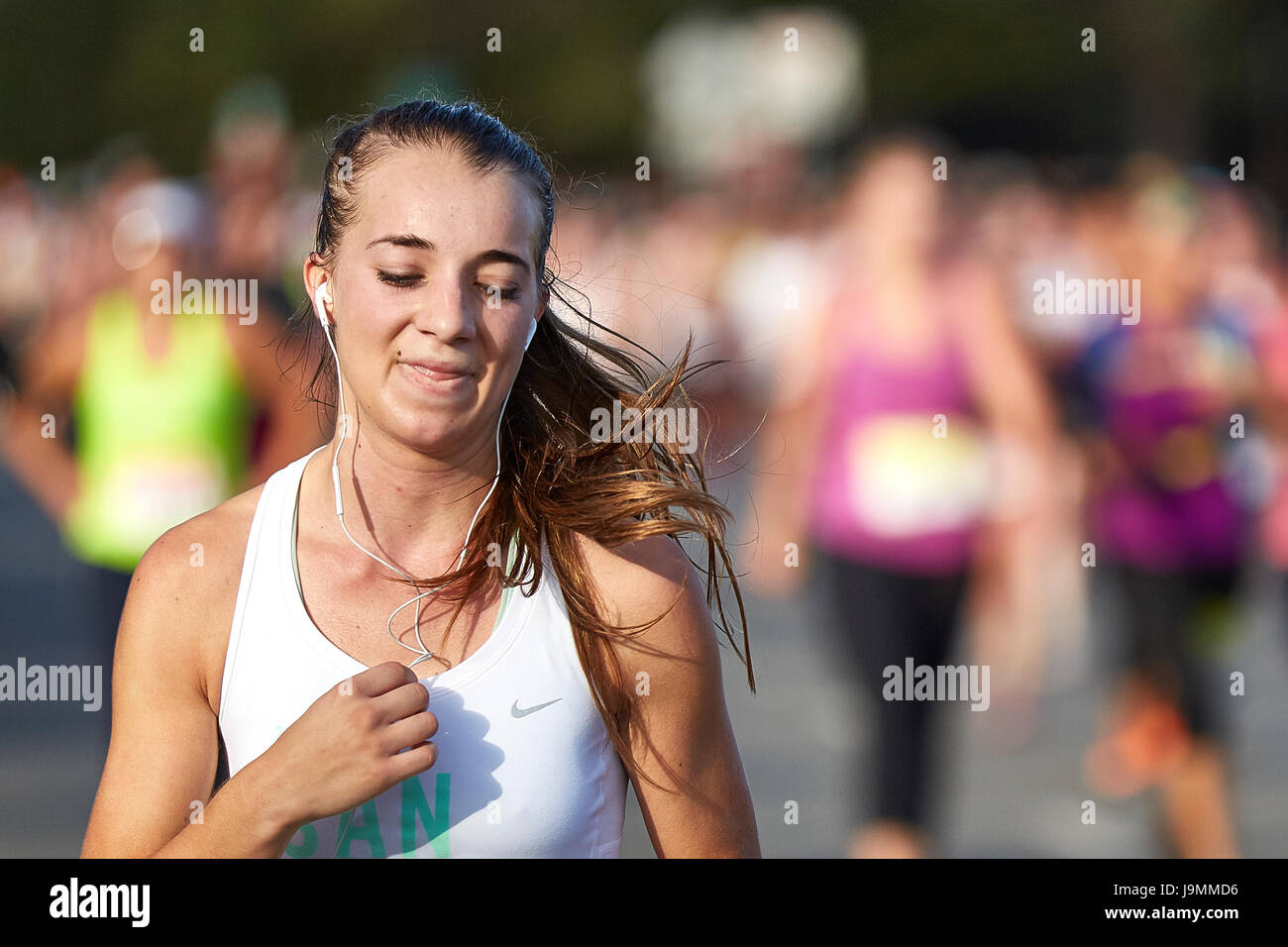 Happy Female Athlete Approaching The Finish Line In The Nike Woman's ...