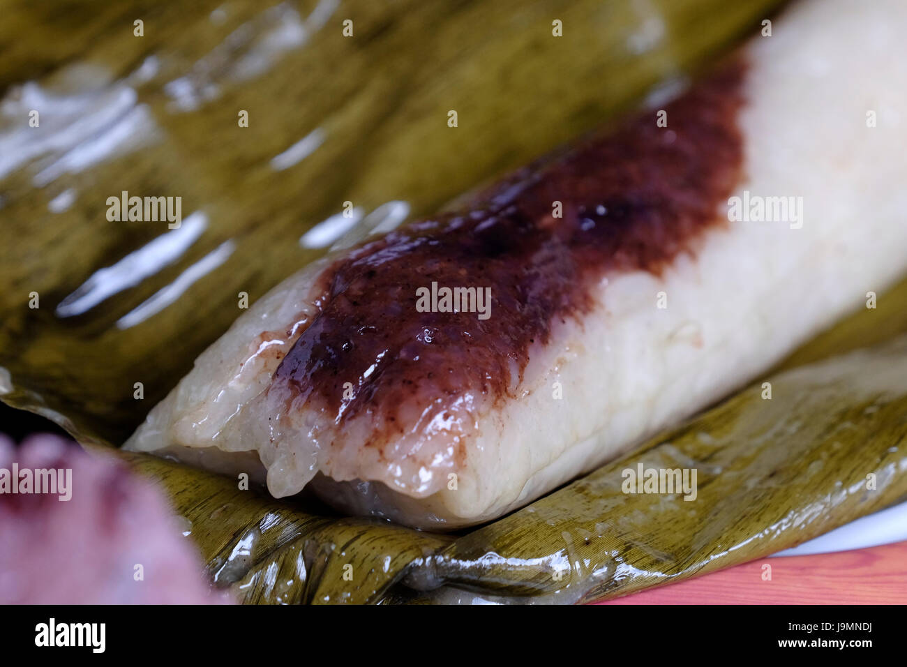 A traditional Bod Bod Chocolate sticky rice folded in banana leaves in ...