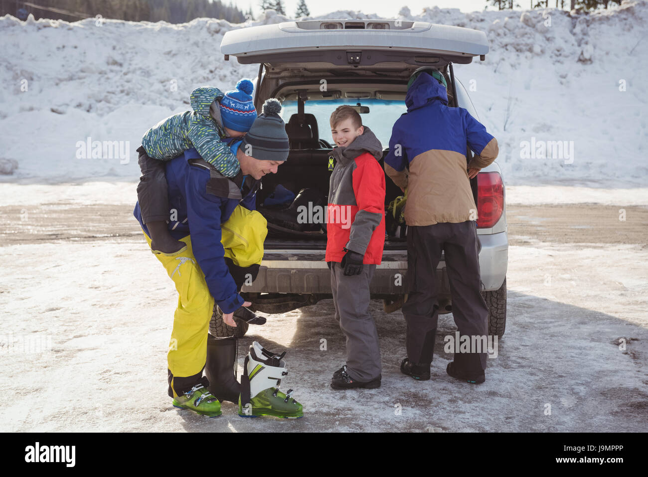 Family preparing for ski during winter Stock Photo - Alamy