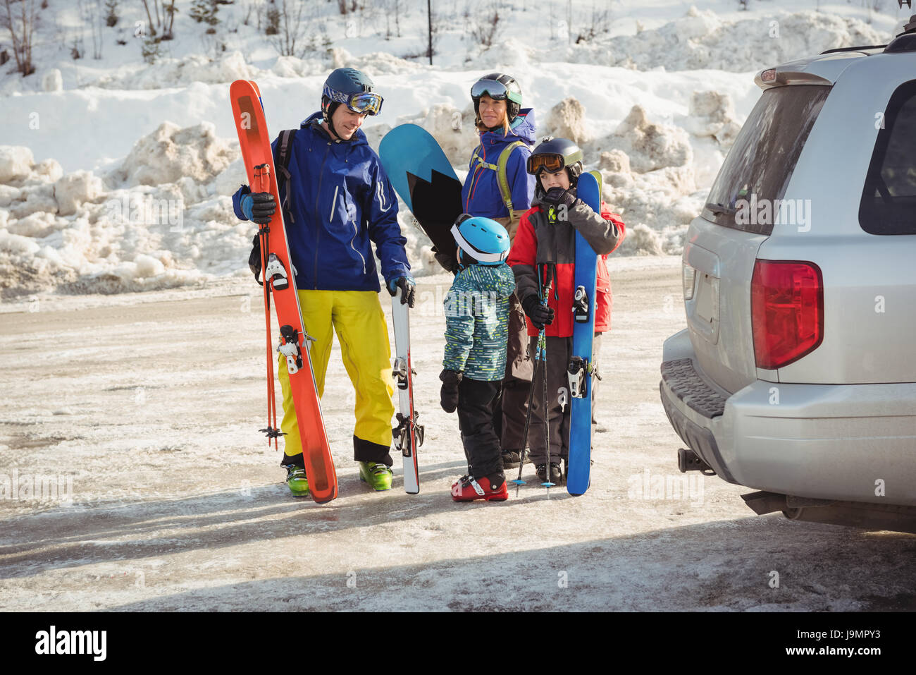 Family preparing for ski during winter Stock Photo - Alamy