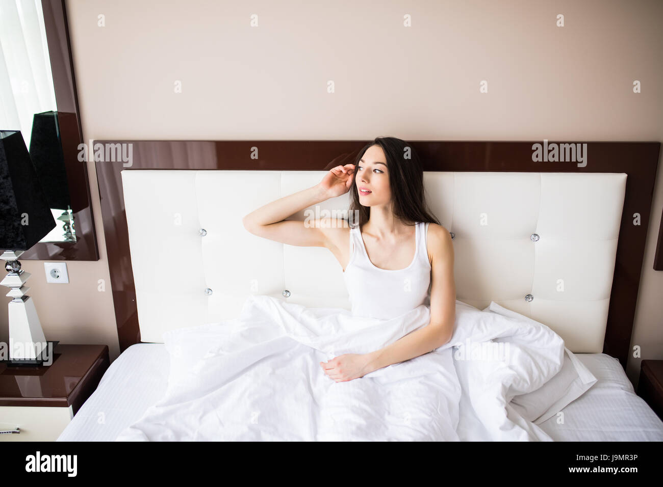 Good morning. Young beautiful girl wake up in the morning at home Stock ...