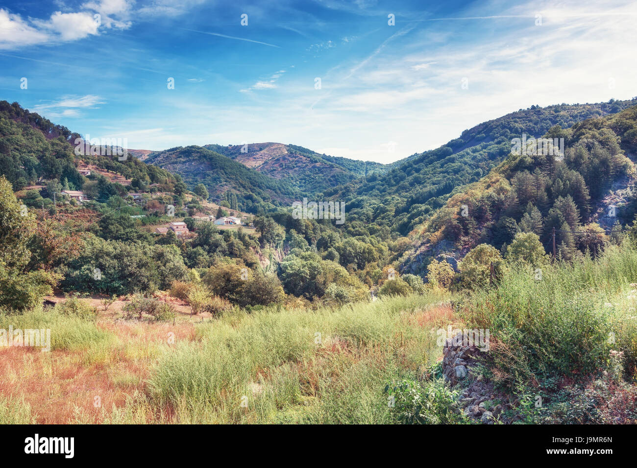 Panorama of a village in a valley of the Ardèche mountains in France ...
