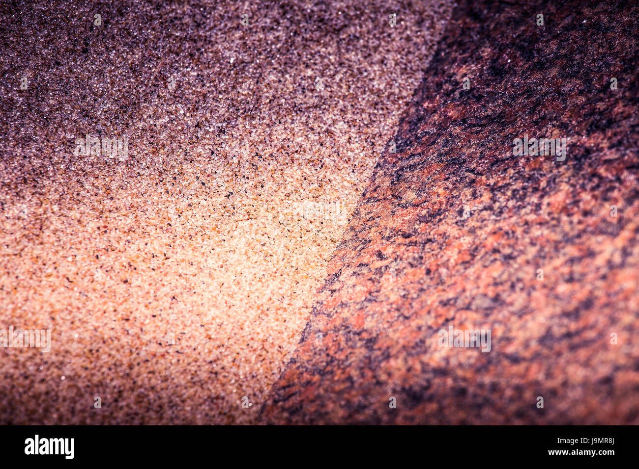 An abstract, high contrast background of a sea sand and rock shapes ...