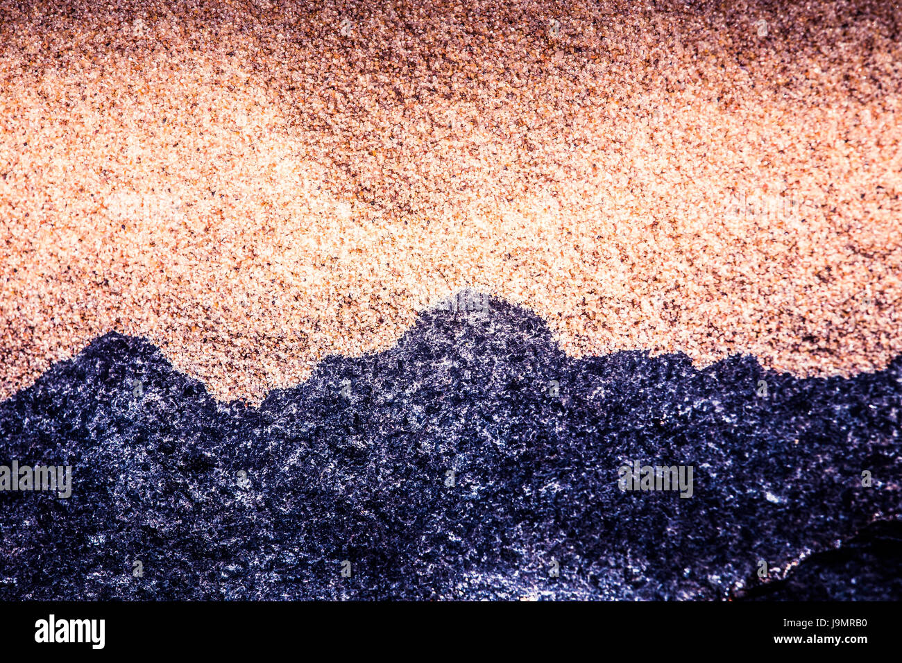 An abstract, high contrast background of a sea sand and rock shapes ...