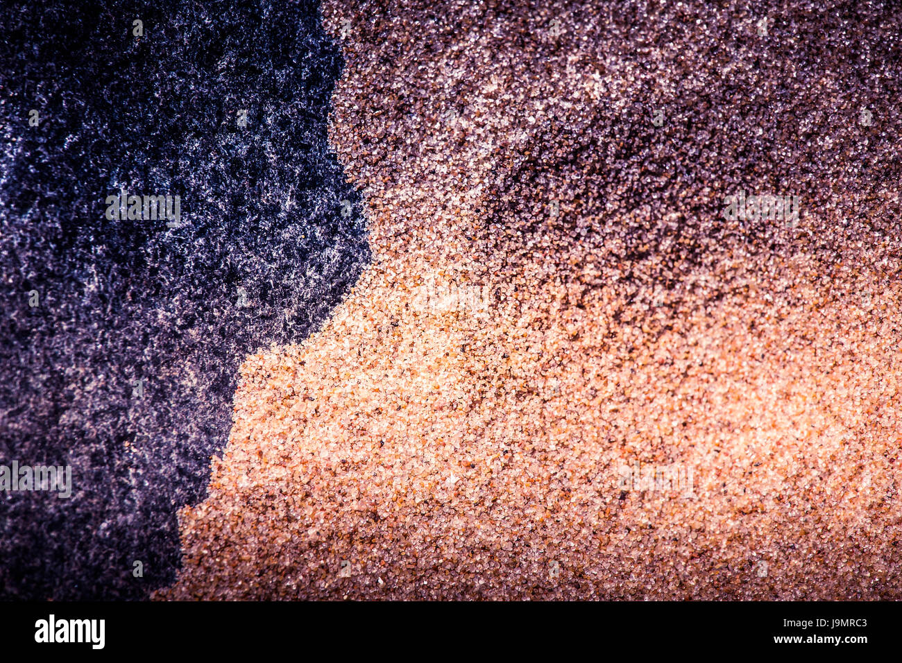 An abstract, high contrast background of a sea sand and rock shapes ...