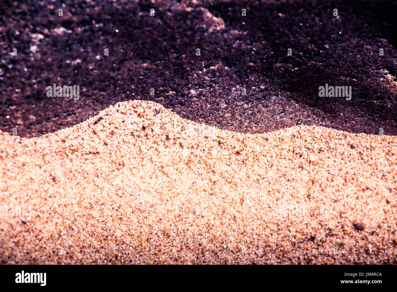 An abstract, high contrast background of a sea sand and rock shapes ...