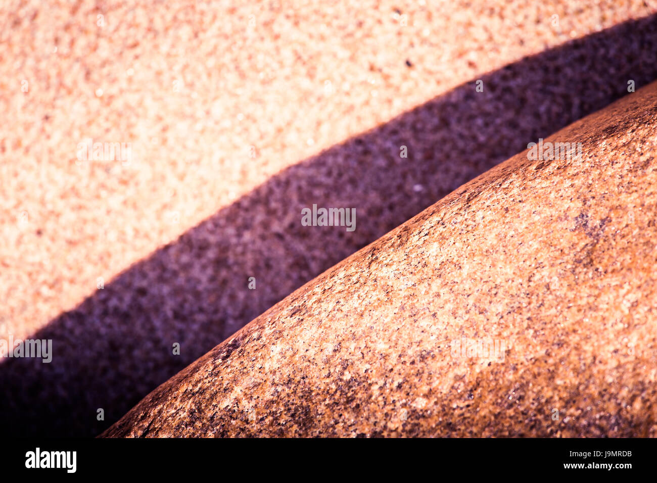 An abstract, high contrast background of a sea sand and rock shapes ...