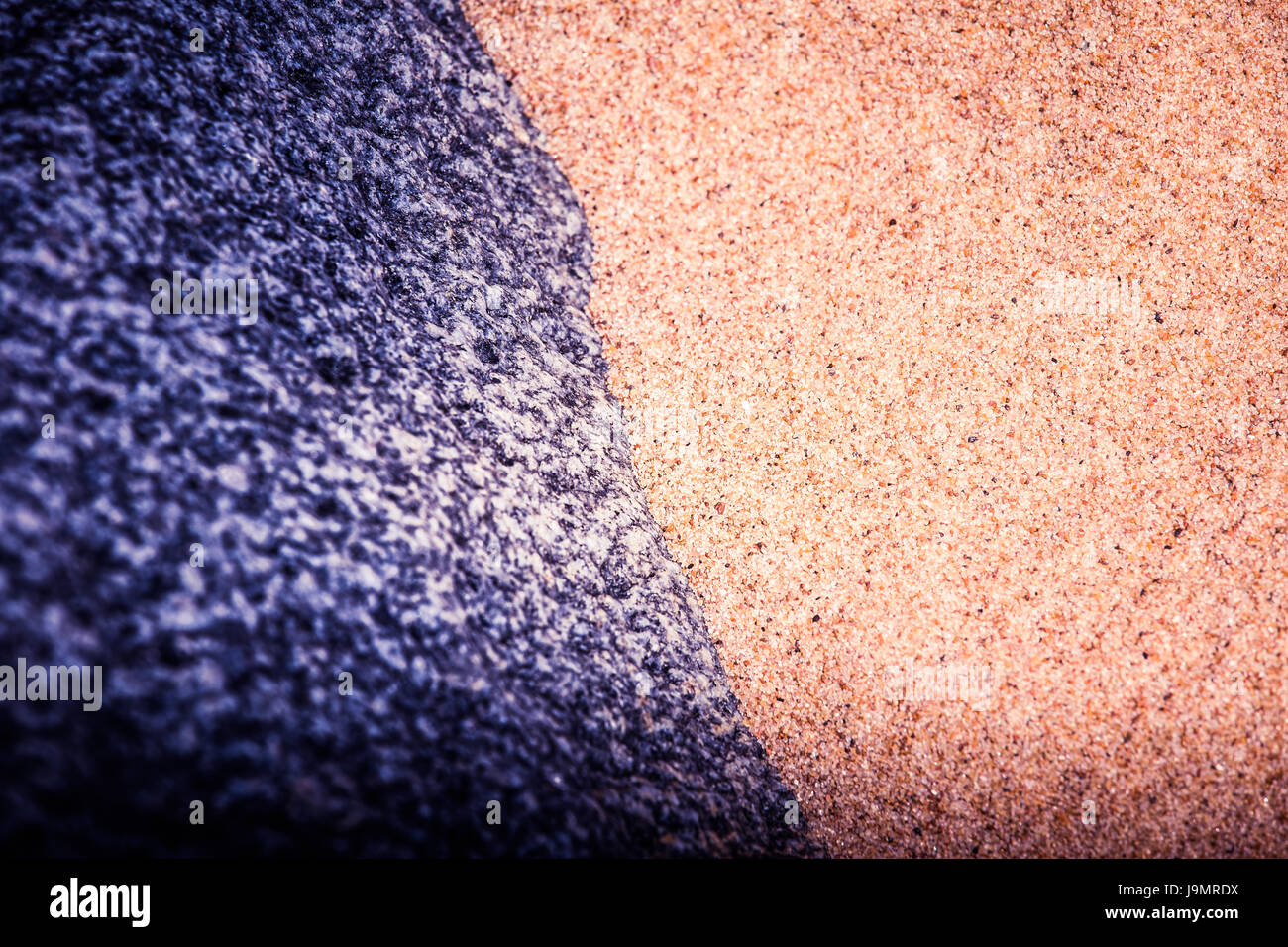 An abstract, high contrast background of a sea sand and rock shapes ...