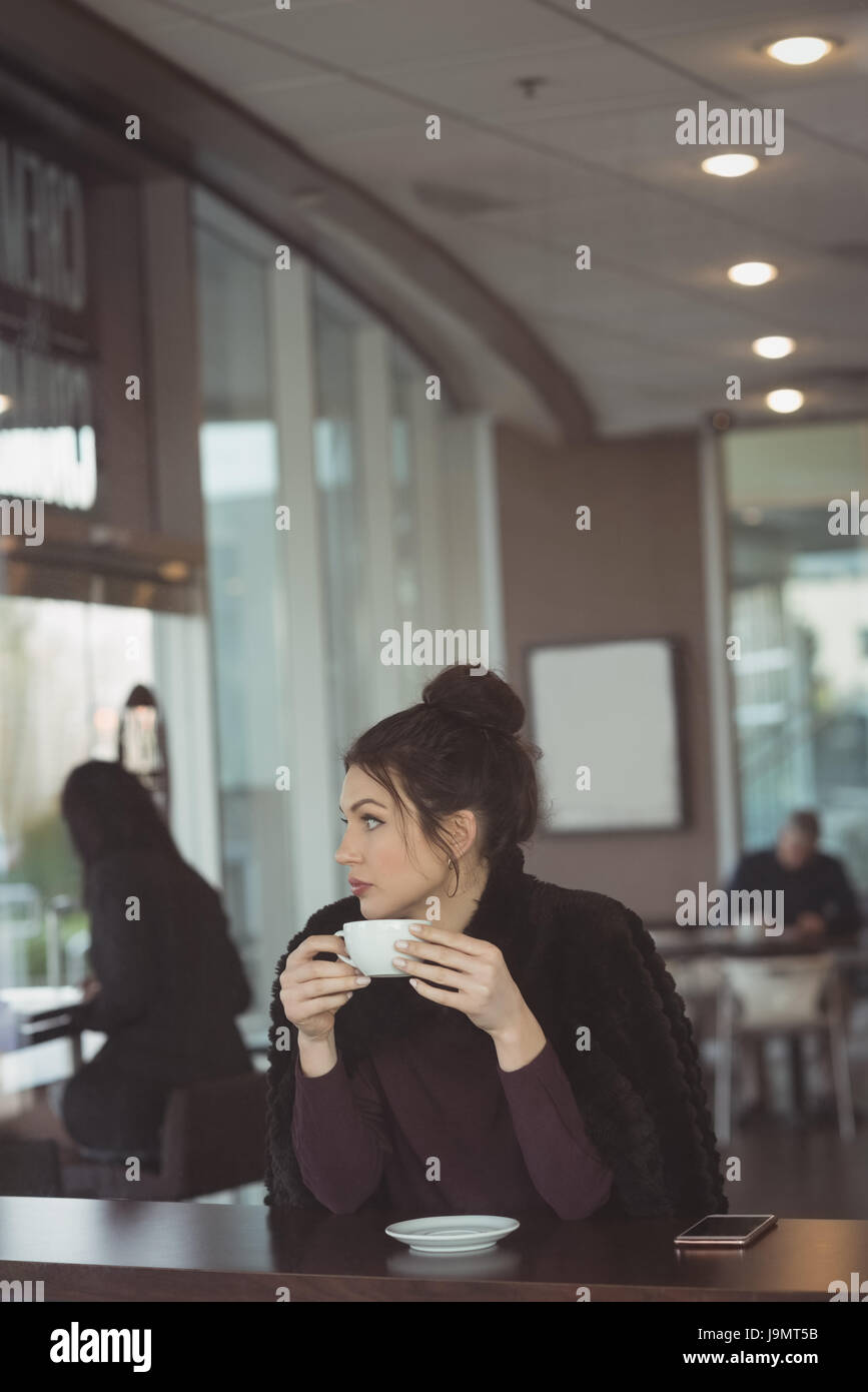 Thoughtful female executive having coffee in office cafeteria Stock ...