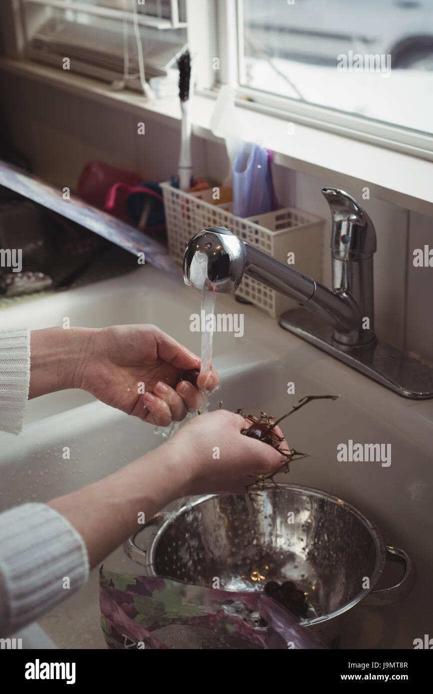 Woman washing utensils hi-res stock photography and images - Alamy