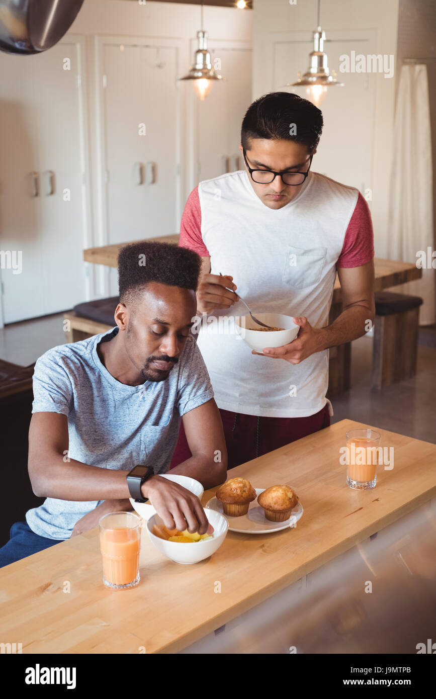 Gay couple having breakfast at home Stock Photo - Alamy