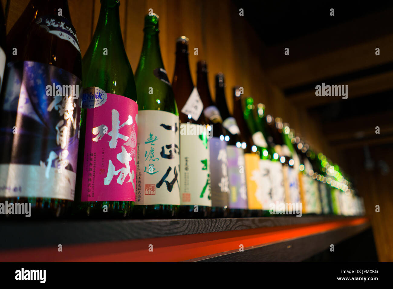 A line of sake bottles on store display Stock Photo - Alamy