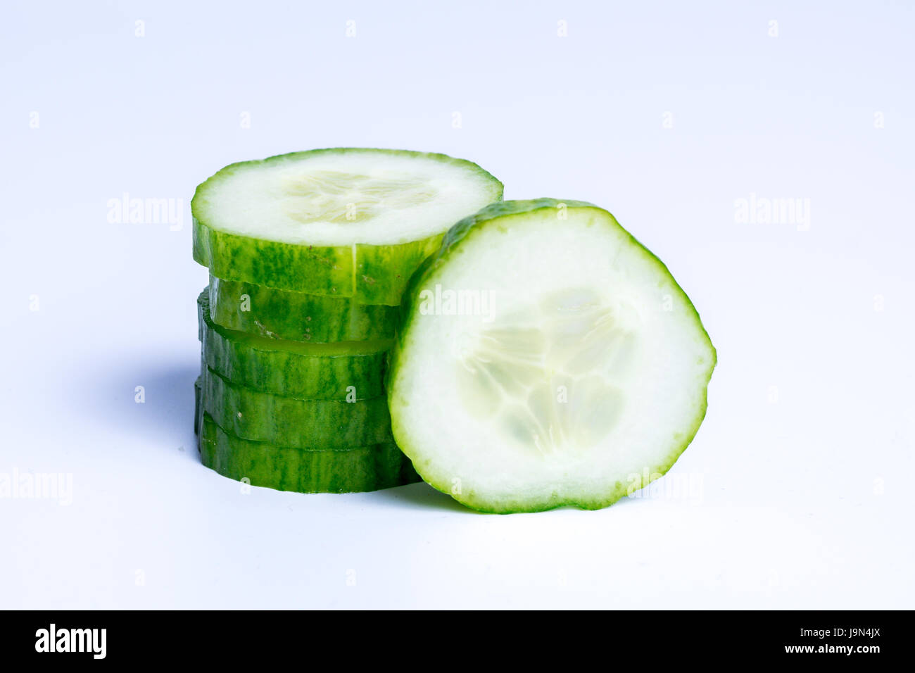Stack of cucumber slices on white background Stock Photo - Alamy
