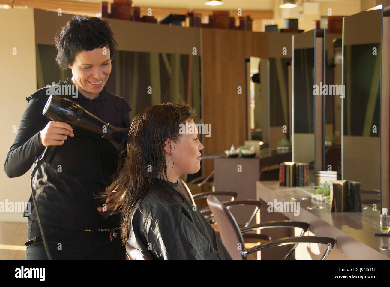 Hairstylist at work at a Lifestyle Salon and Spa Stock Photo - Alamy