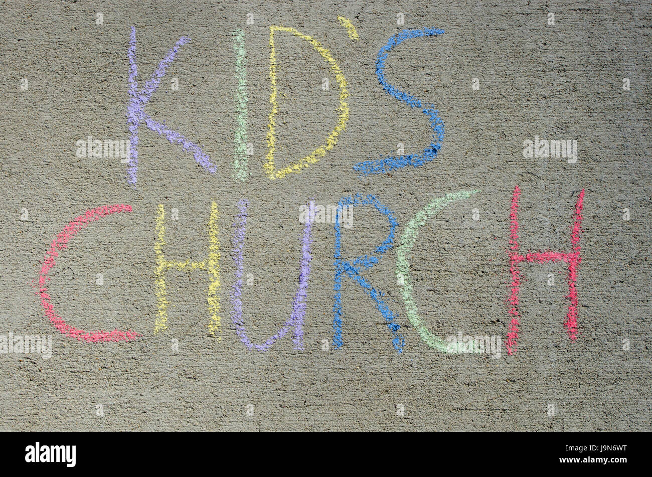 Kid's Church written large on sidewalk in colorful chalk Stock Photo ...
