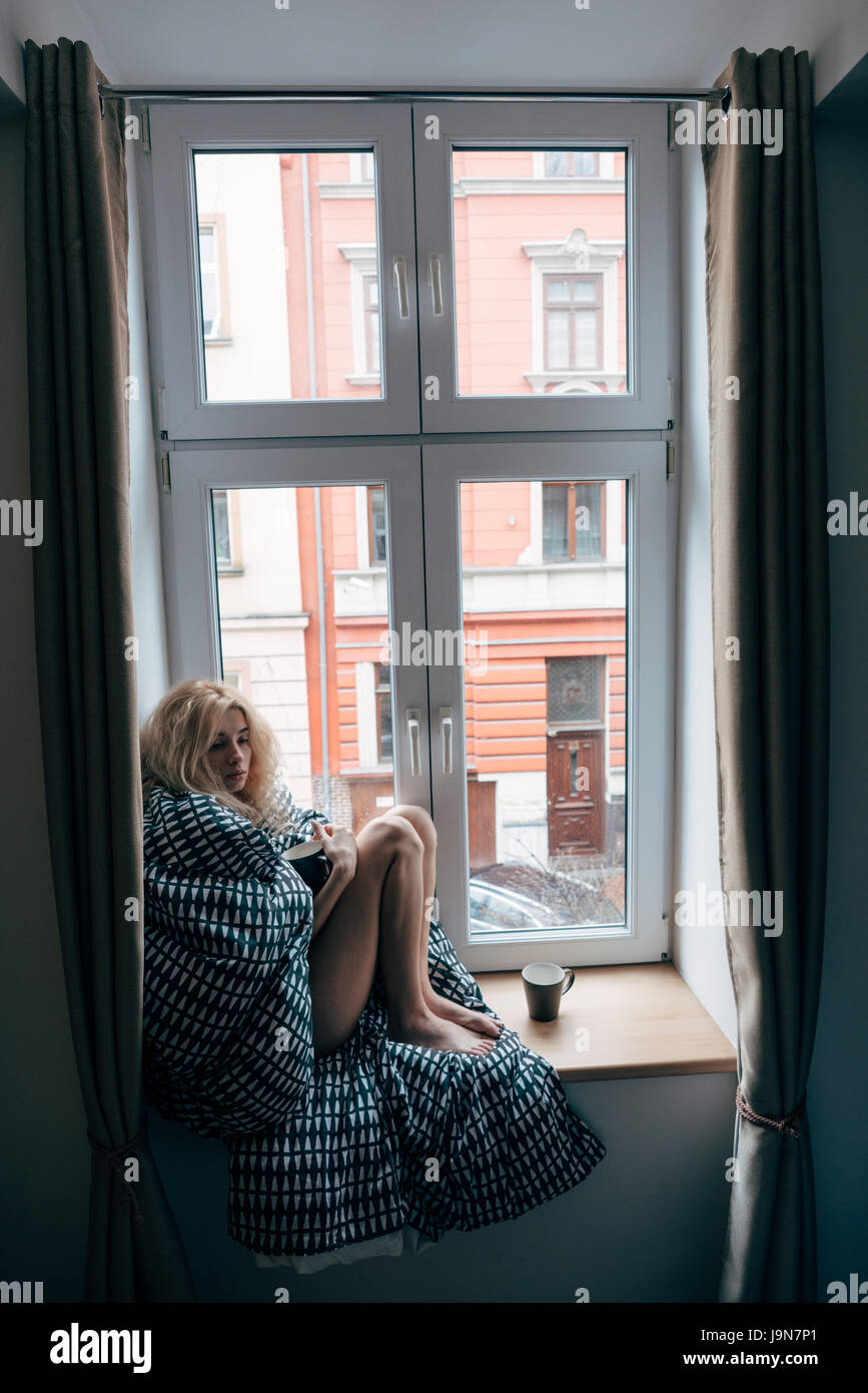 girl sitting on a window Stock Photo - Alamy