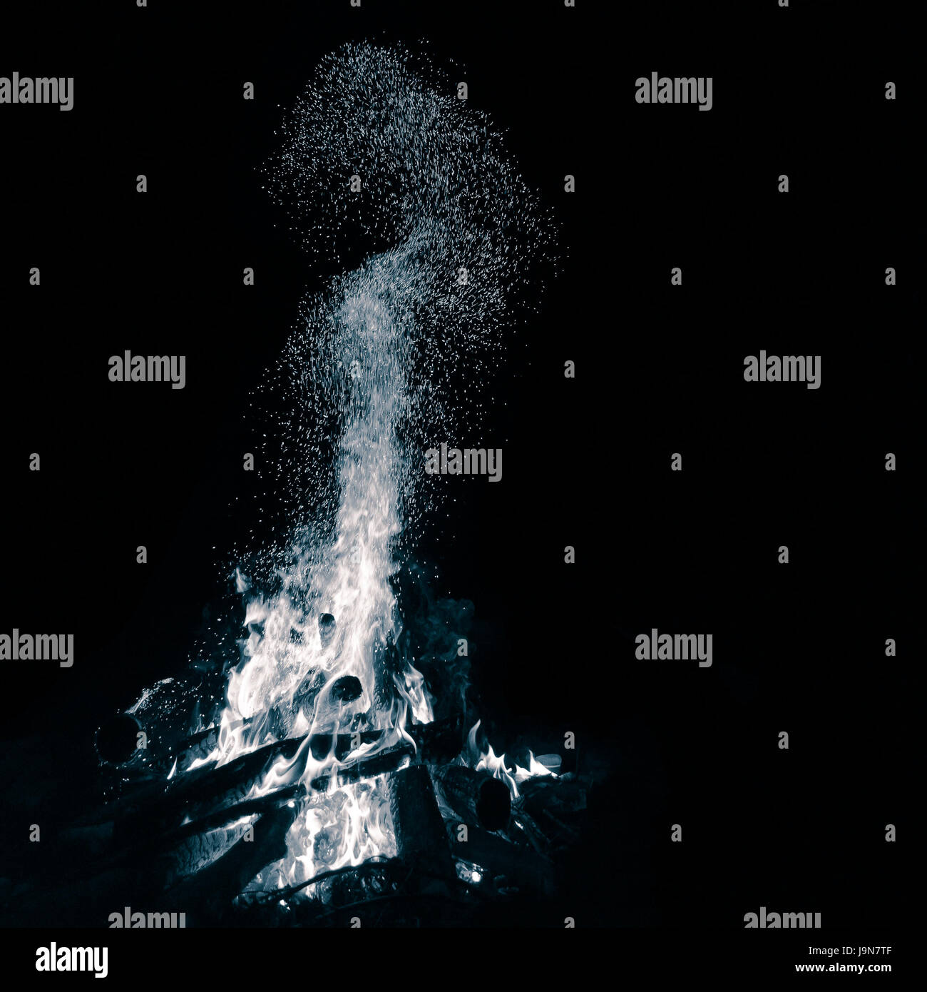 Blue bonfire with flying sparks isolated on black Stock Photo - Alamy