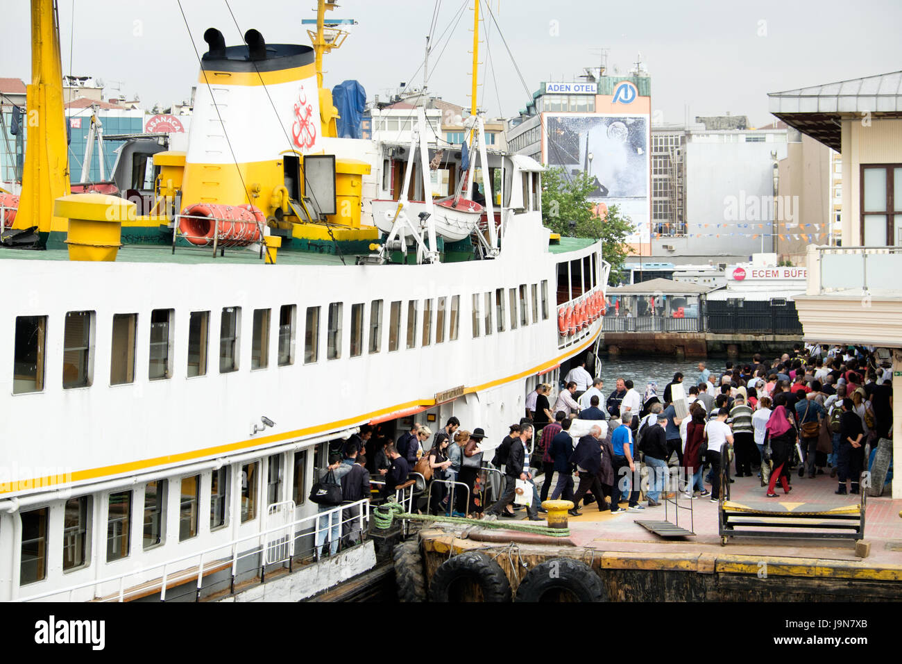 Passengers disembarking a ferry at a ferry terminal in Kadıköy ...