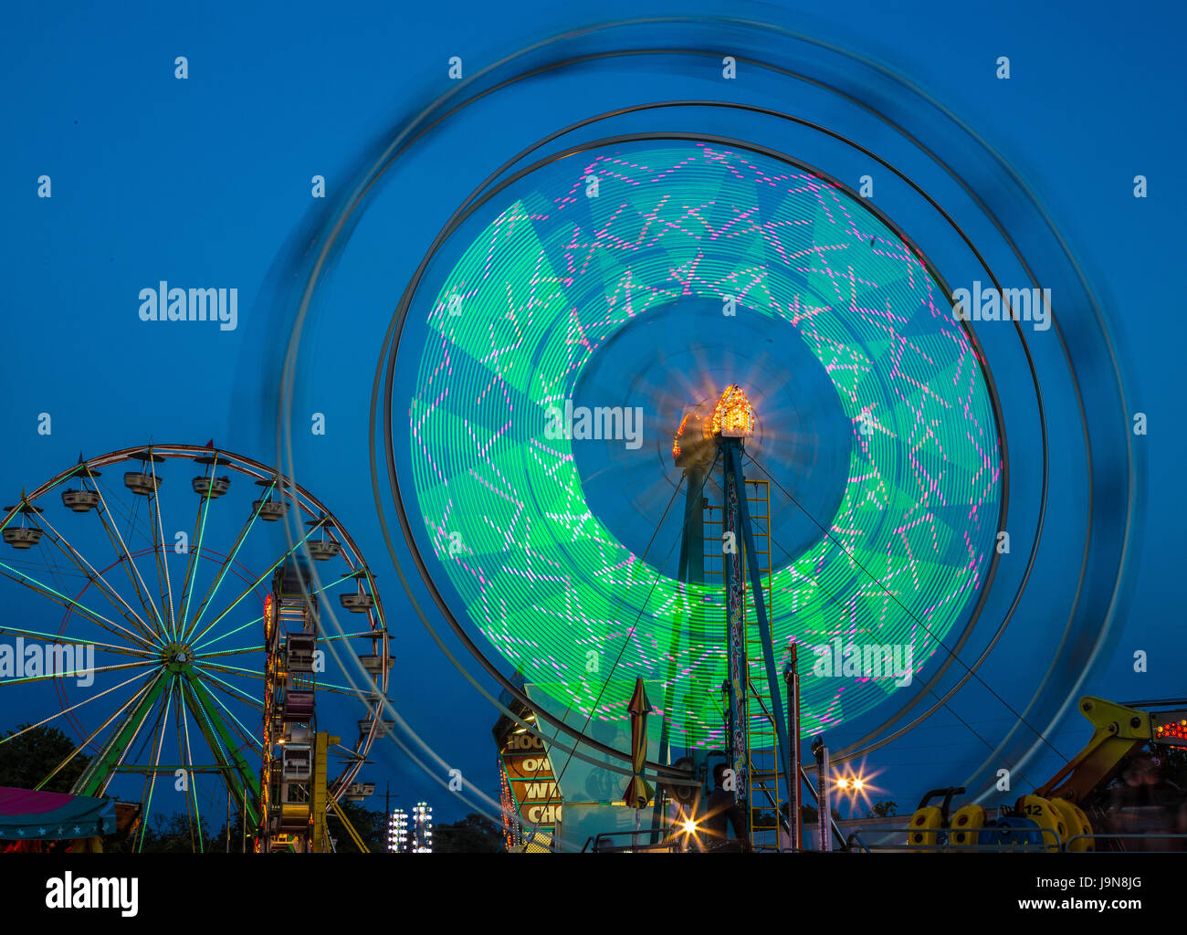 Spinning rides are colorful at the county fair Stock Photo - Alamy