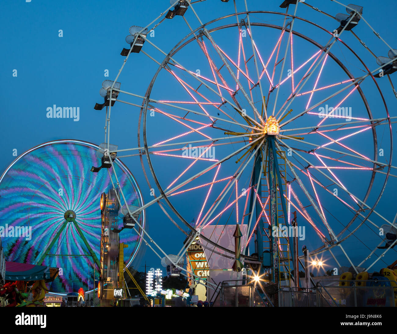 Spinning rides are colorful at the county fair Stock Photo - Alamy