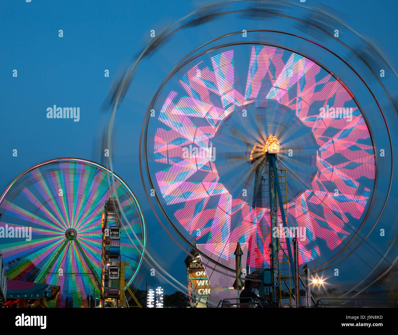 Spinning rides are colorful at the county fair Stock Photo - Alamy