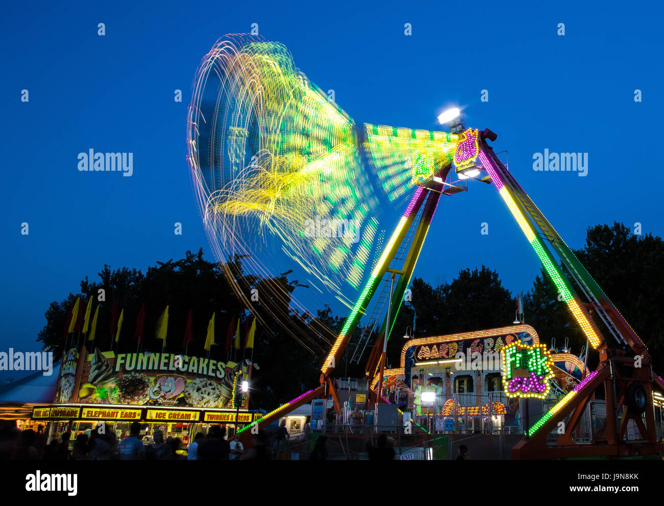 Spinning rides are colorful at the county fair Stock Photo - Alamy