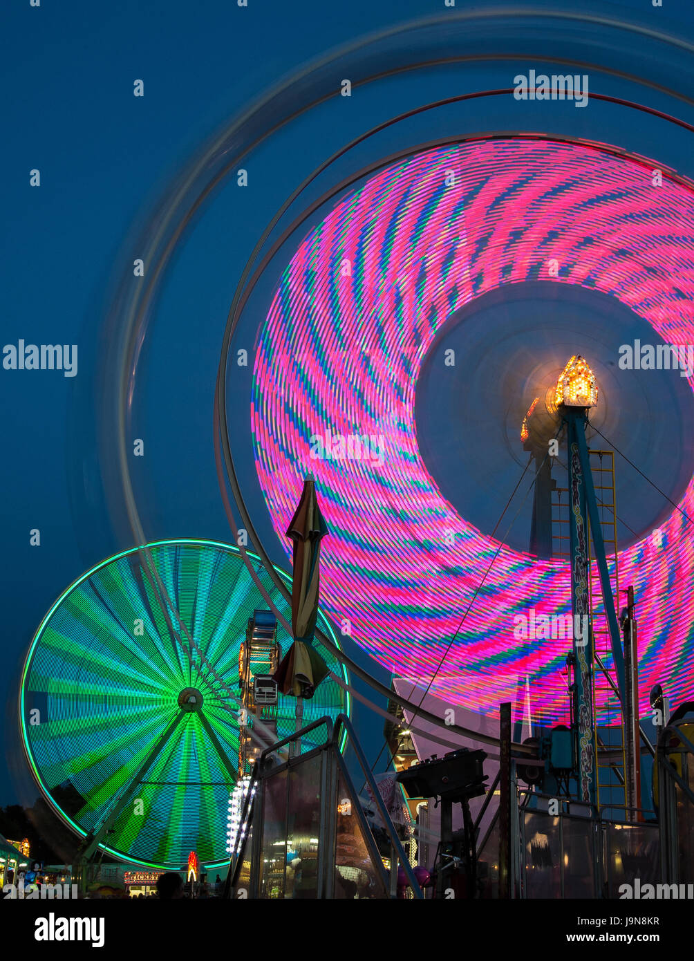Spinning rides are colorful at the county fair Stock Photo - Alamy