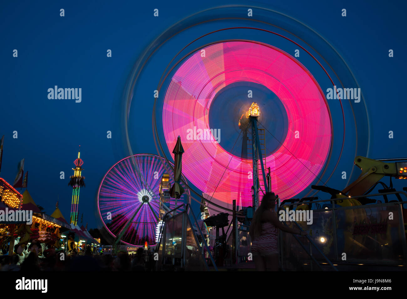 Spinning rides are colorful at the county fair Stock Photo - Alamy