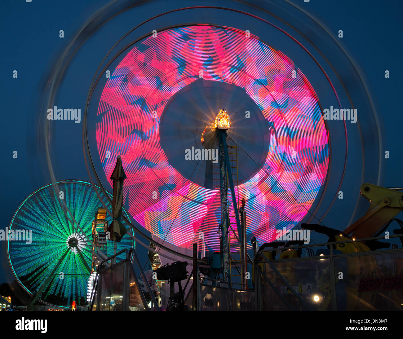 Spinning rides are colorful at the county fair Stock Photo - Alamy
