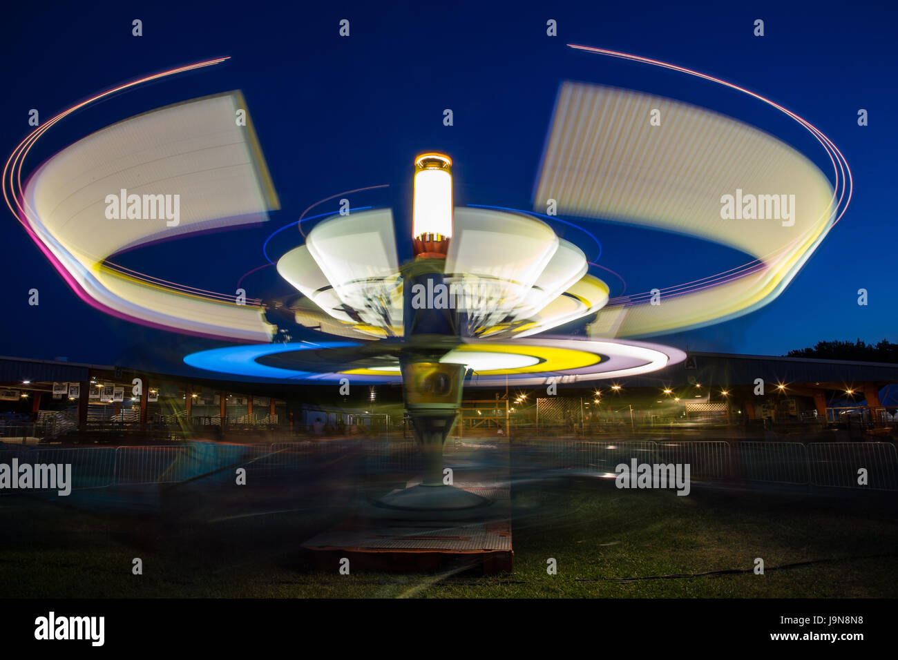 Spinning rides are colorful at the county fair Stock Photo - Alamy