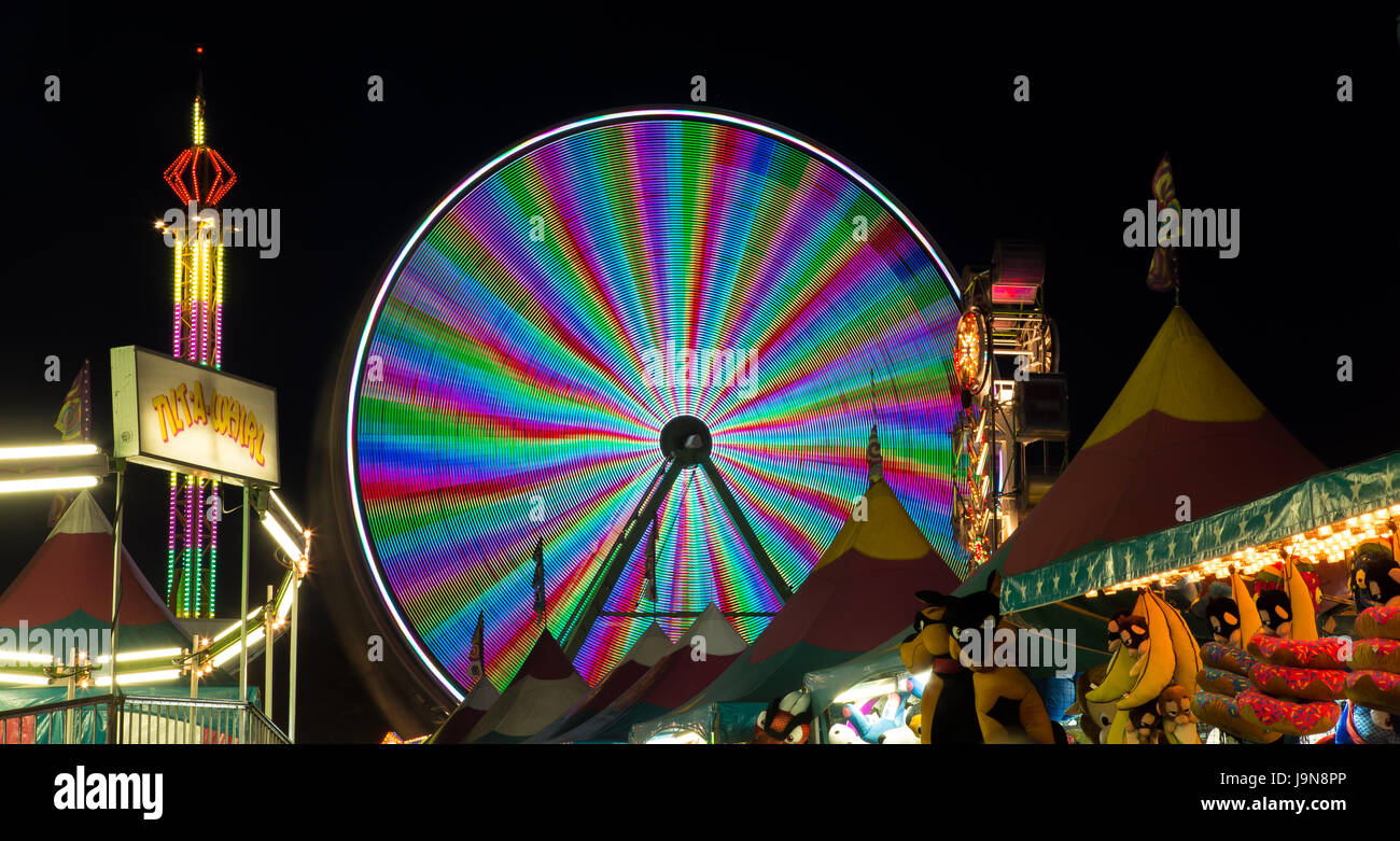 Spinning rides are colorful at the county fair Stock Photo - Alamy